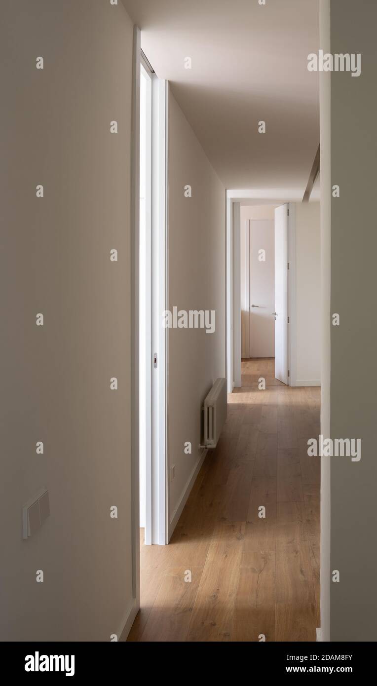 Perspective view of a long corridor with lateral light inlets. Modern ...
