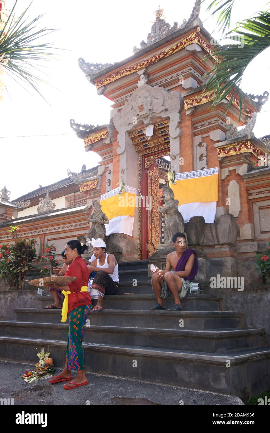 Local Balinese people sitting on the steps to their neighbourhood ...