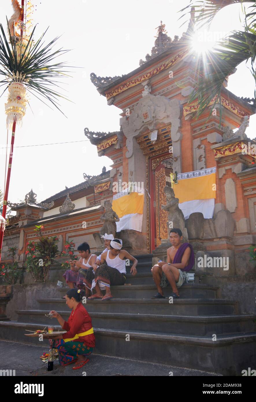 Local Balinese people sitting on the steps to their neighbourhood ...