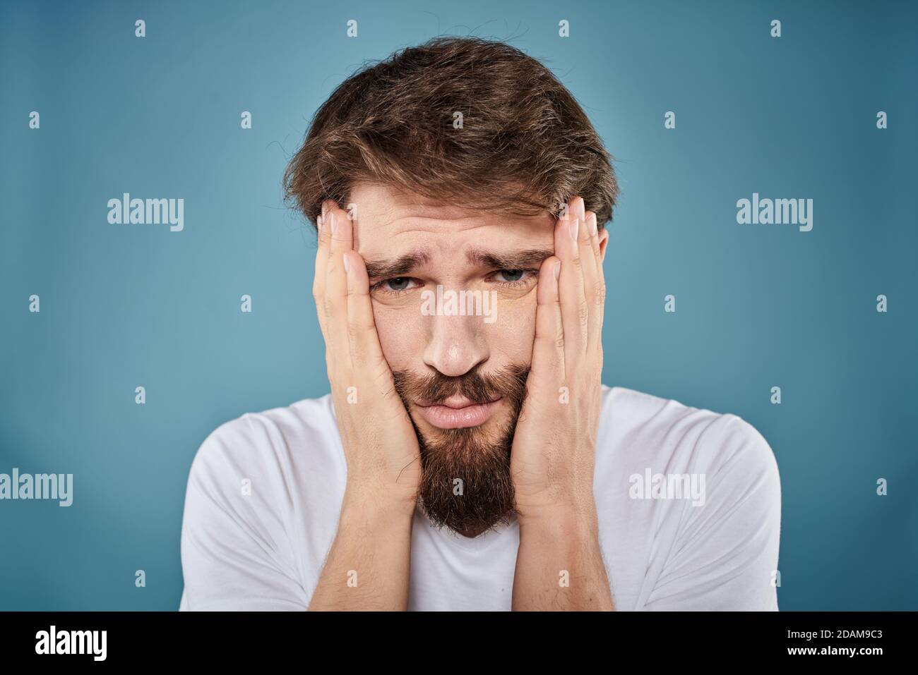 Bearded man displeased facial expression emotions close-up blue ...
