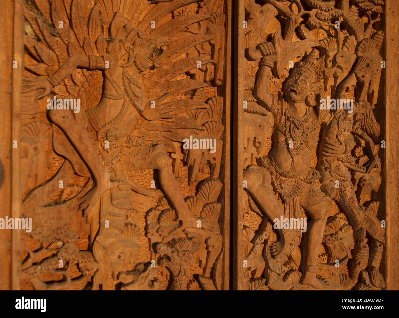 Intricate wooden carving on temple doors depicting scenes from Hindu ...