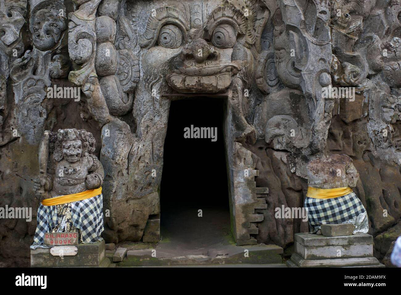 Elaborately carved entrance to the cave at Goa Gajah. Ubud, Bali ...