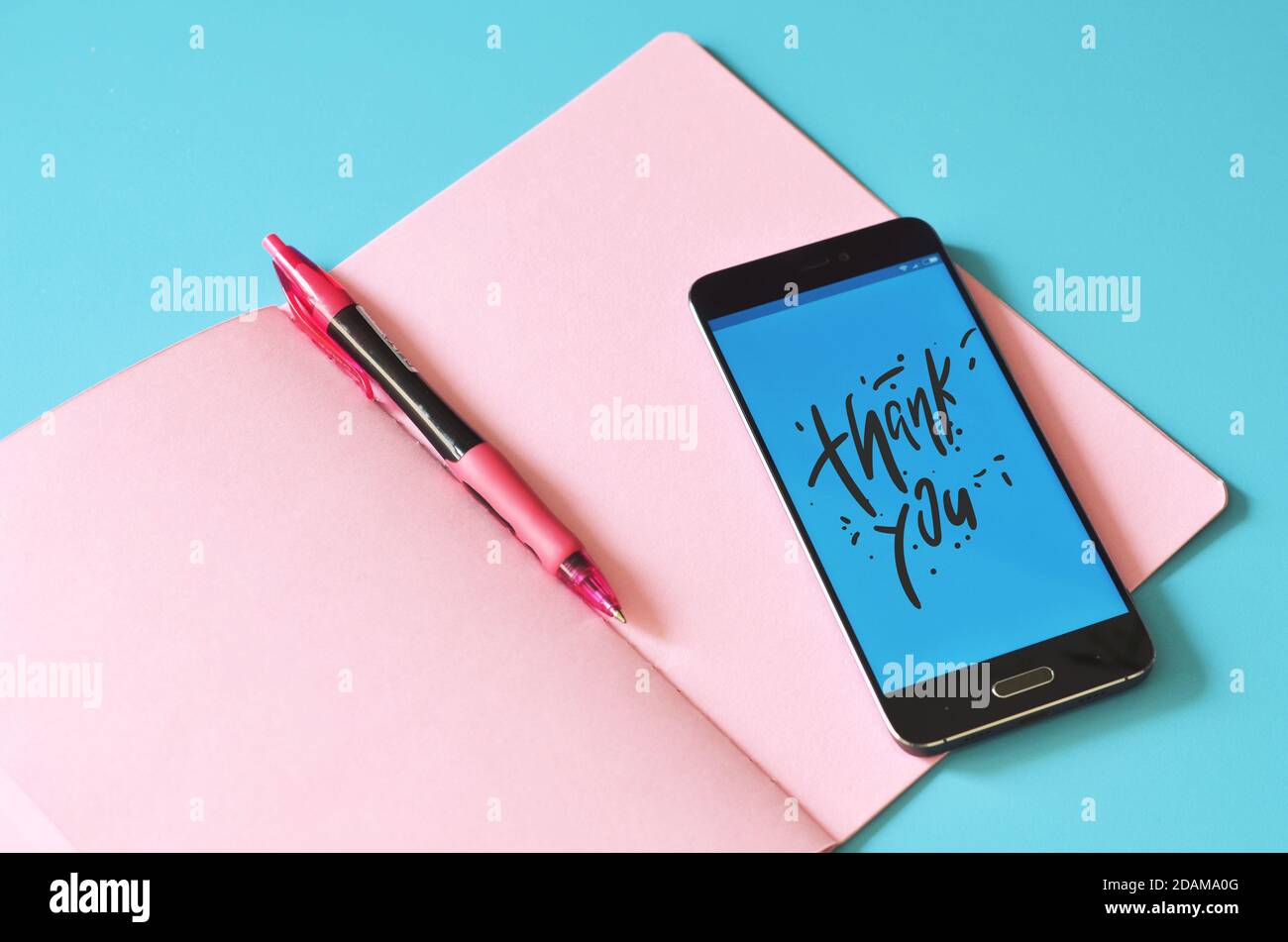Smart phone which displaying Thank You and note book Stock Photo - Alamy