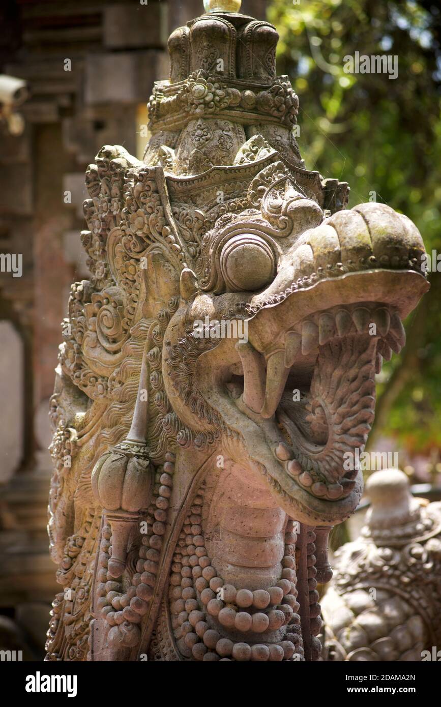 Stone carved Naga statue at Tirta Empul, Bali, Indonesia. Naga ...