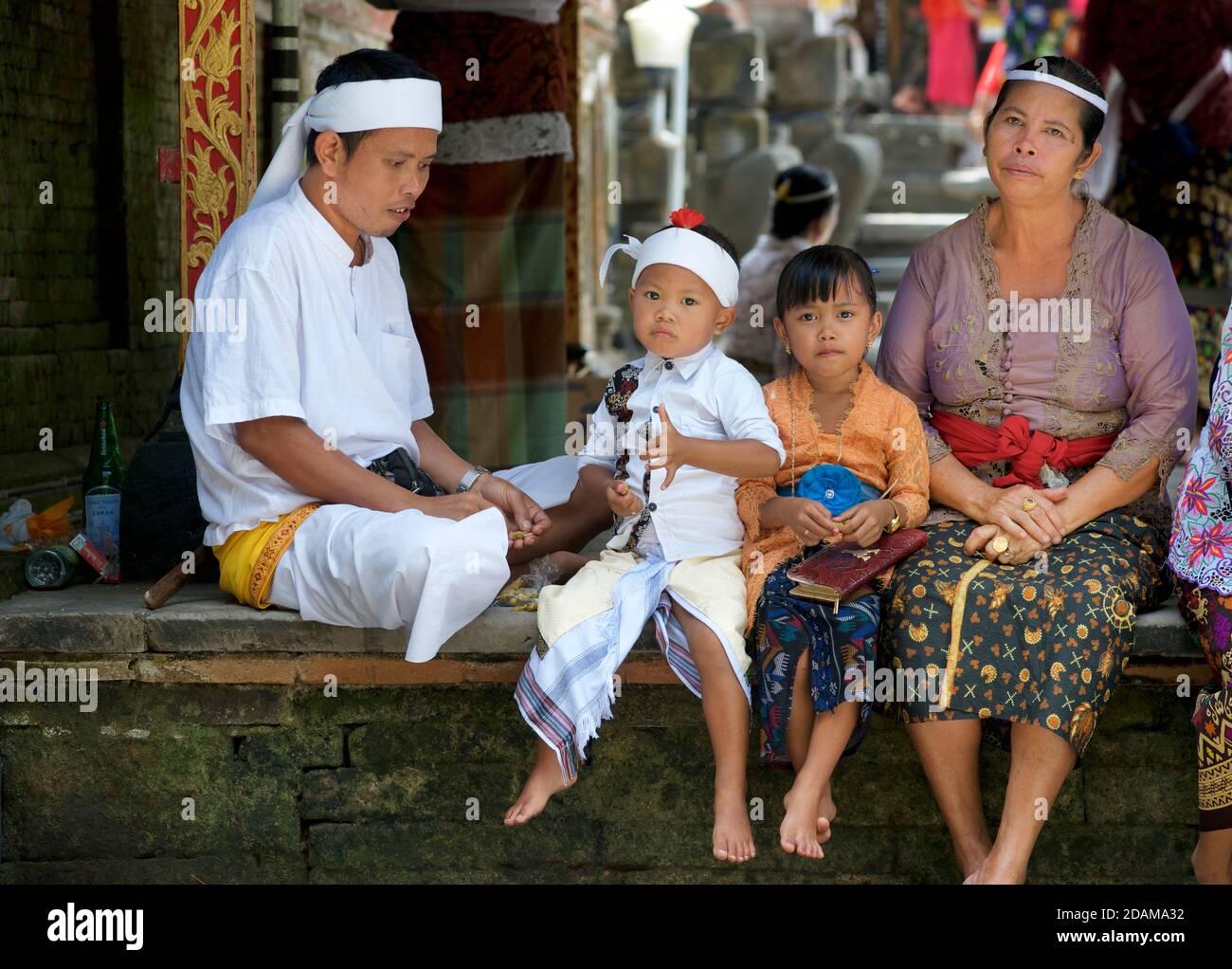 Balinese family relaxing at Tirta Empul temple during Galungan ...