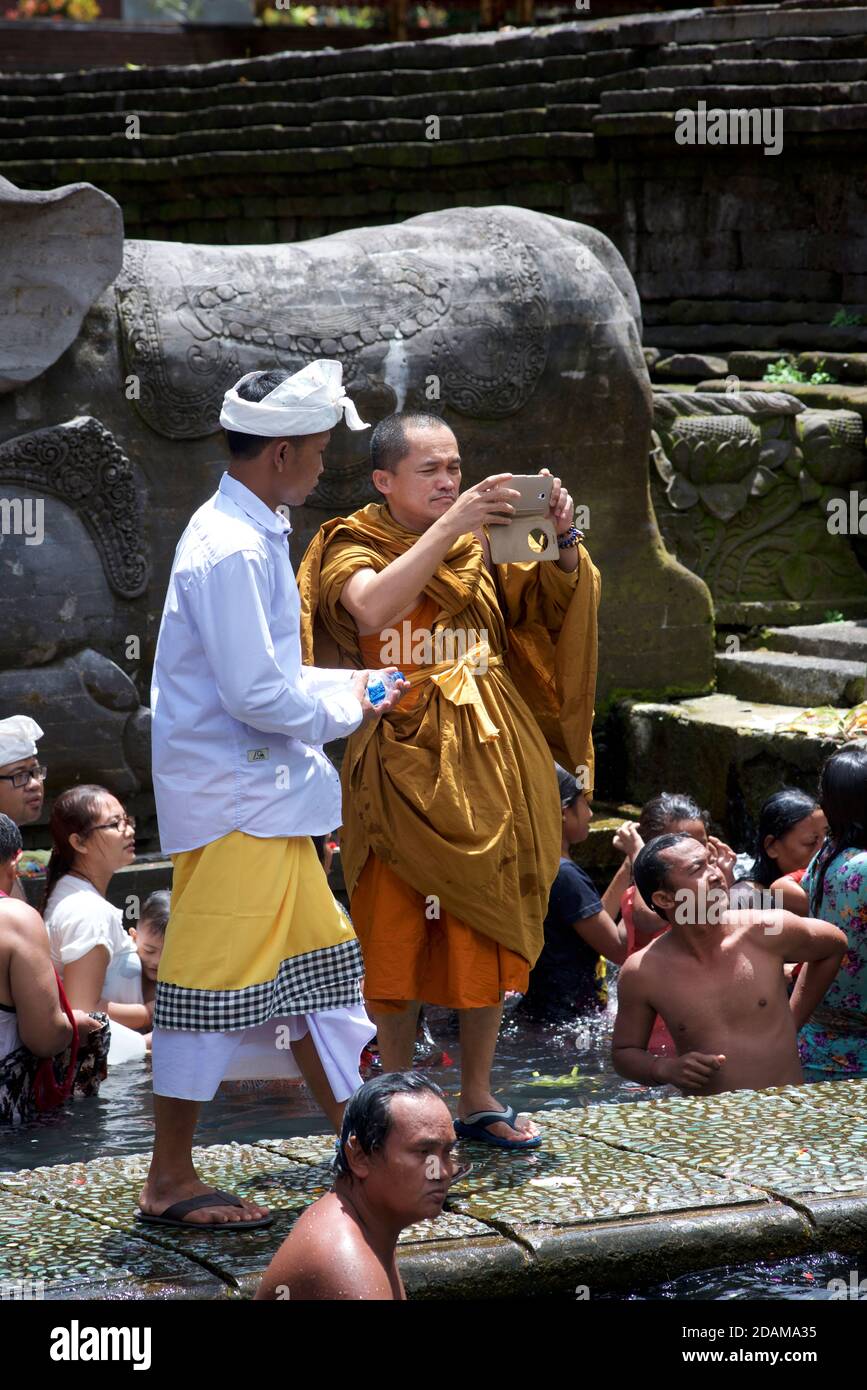 Theravada buddhist monk visiting the Hindu temple complex at Tirta ...