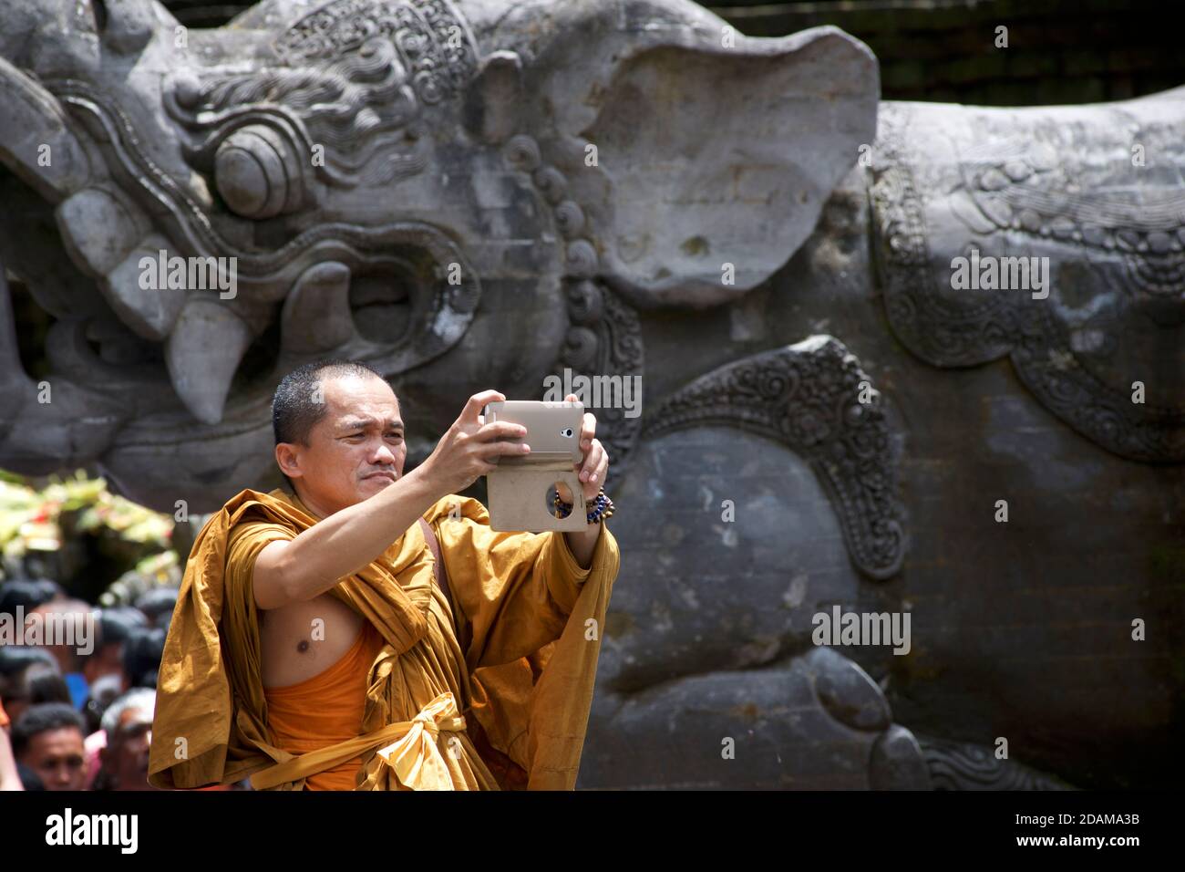 Theravada buddhist monk visiting the Hindu temple complex at Tirta ...