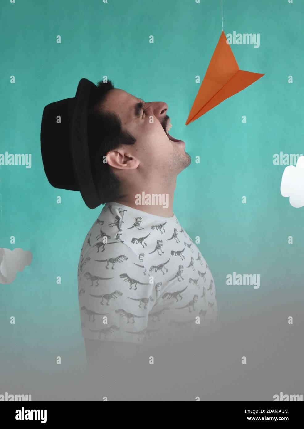 Guy with paper airplane and blue background Stock Photo - Alamy