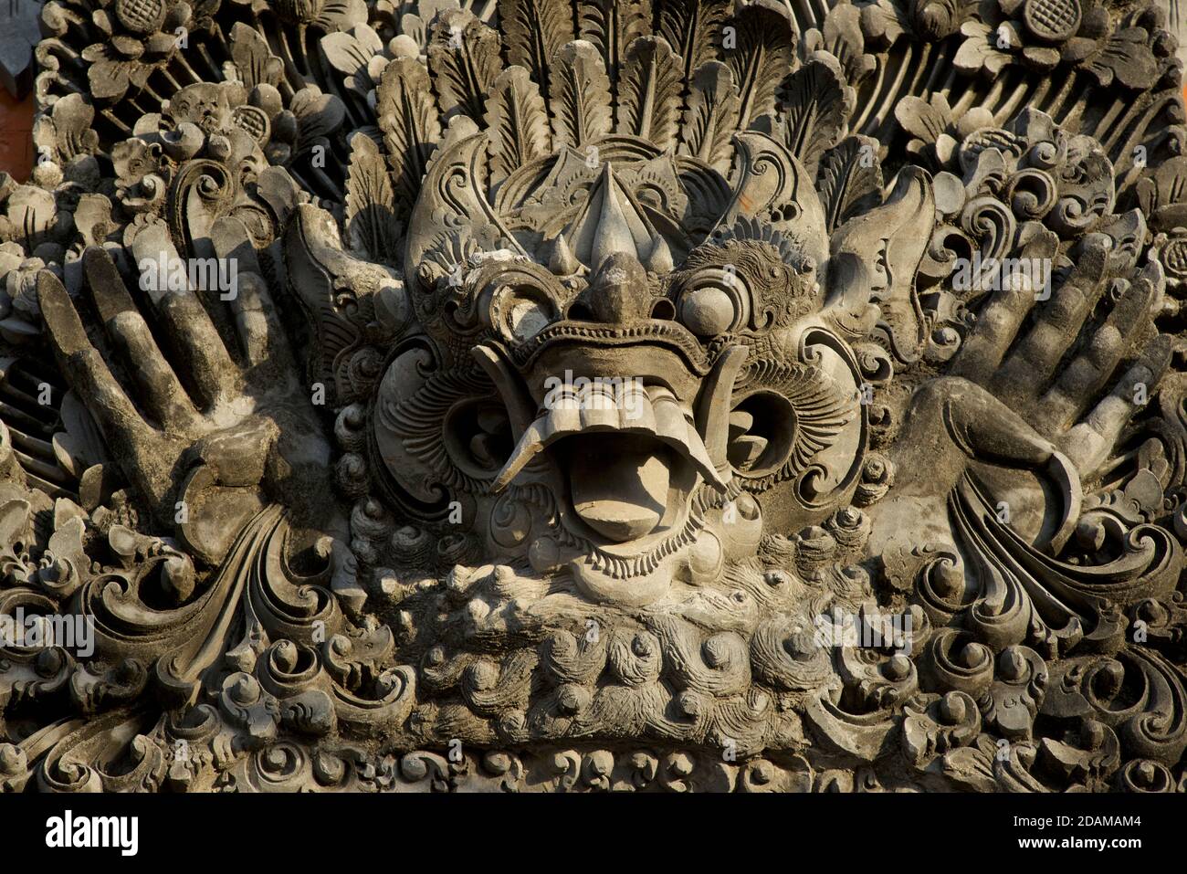 Balinese temple architecture. A fierce Bhoma carved on a temple gateway ...