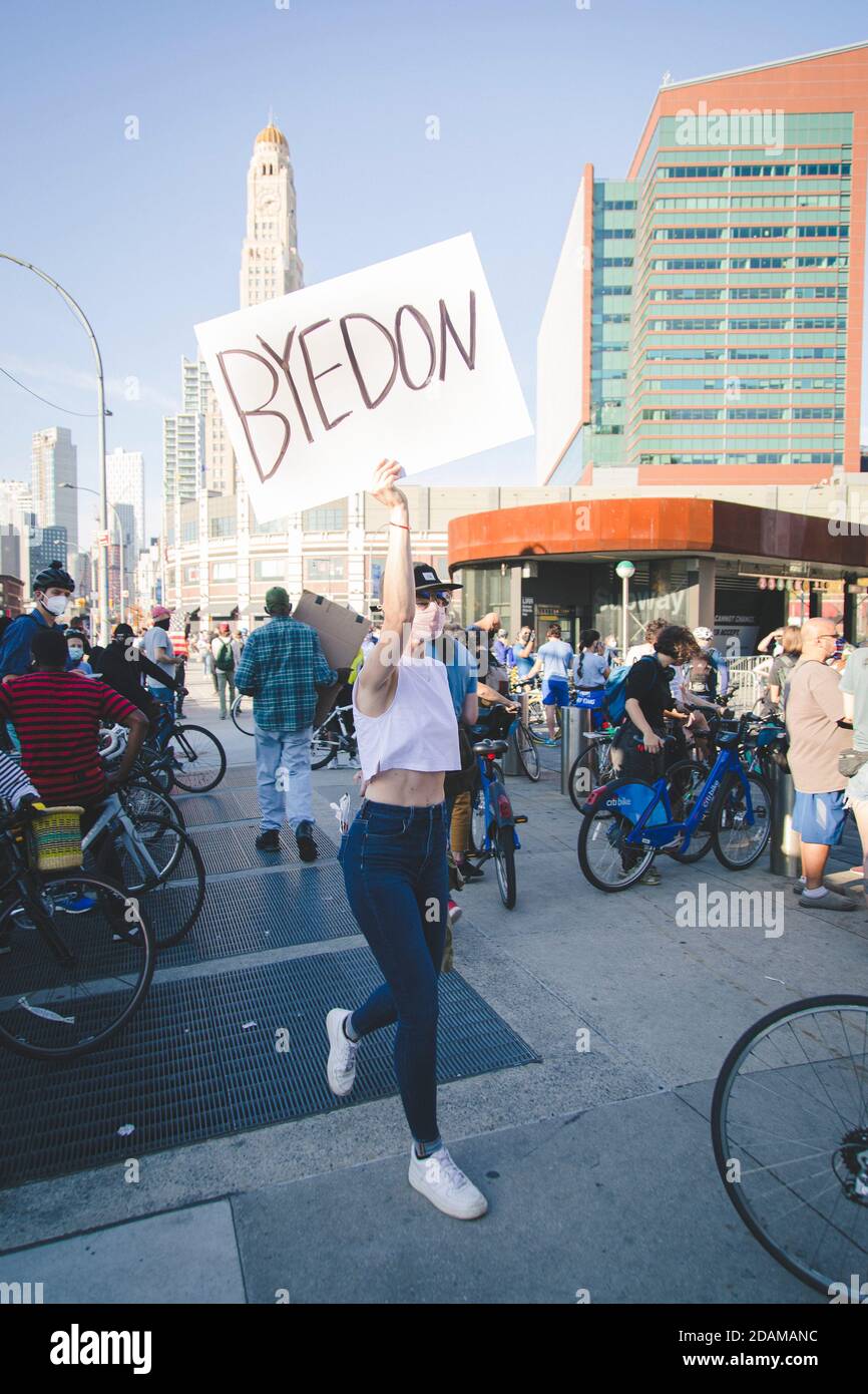 Woman walking in Crowd with "Byedon" Sign outside Barclays Center ...
