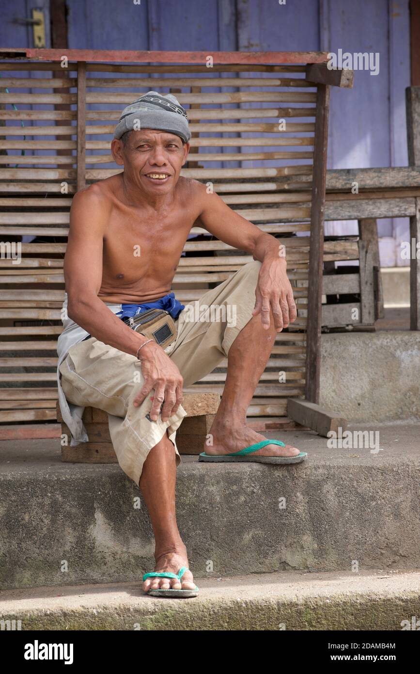 Portrait of a Balinese man sitting at market. Amlapura, Bali, Indonesia ...
