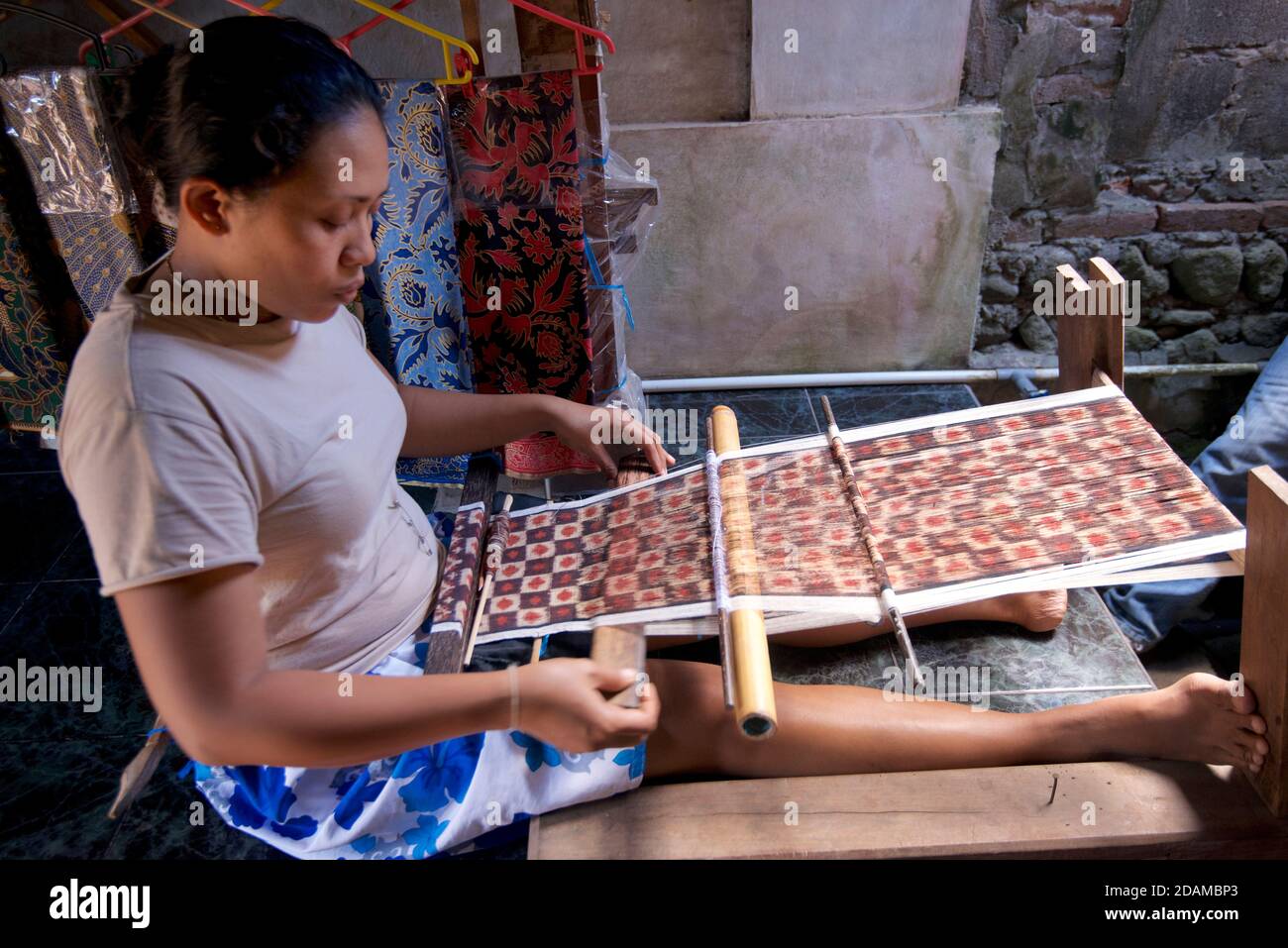 Geringsing, double ikat cloth being woven on a hipstrap in the village ...