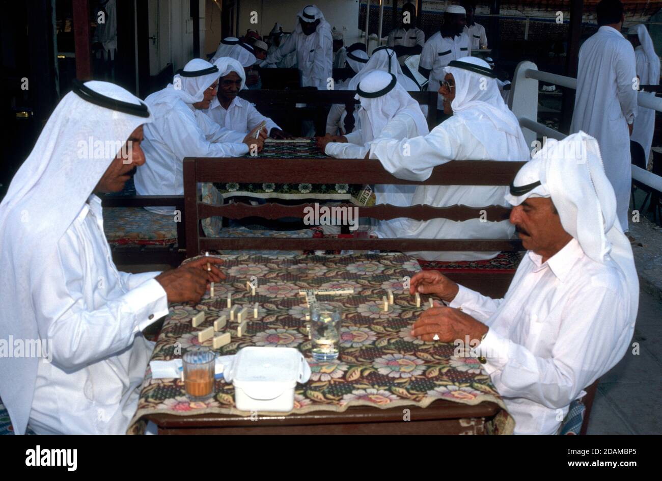 Qatar, Ramadan in Doha, tea house with men playing dominoes 1995 Stock ...