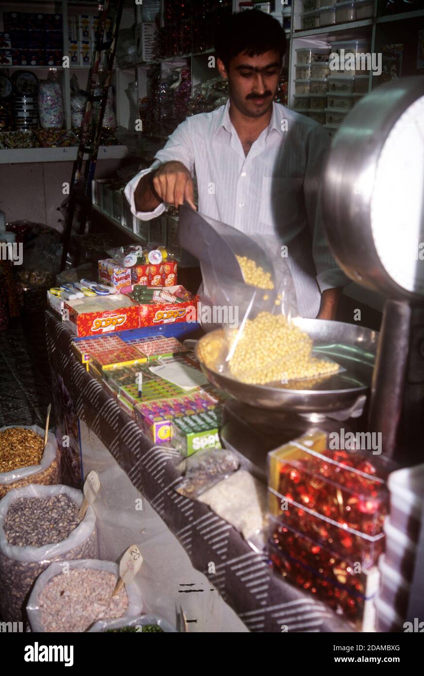 Weighing nuts, Iranian shop in Doha souq in Qatar, 1995 Stock Photo - Alamy