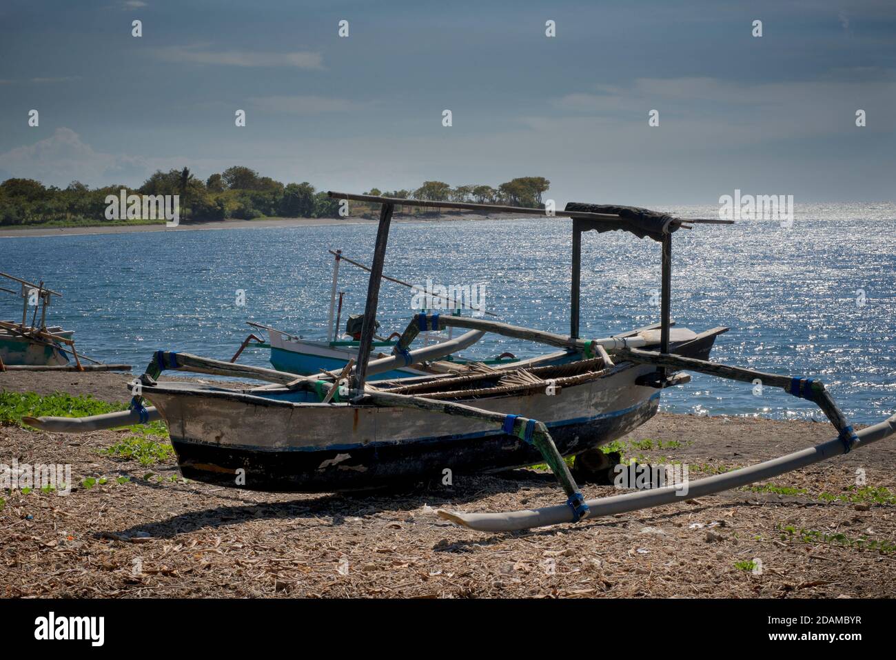 Indonesian outrigger canoe on a beach, East Lombok, Indonesia Stock ...