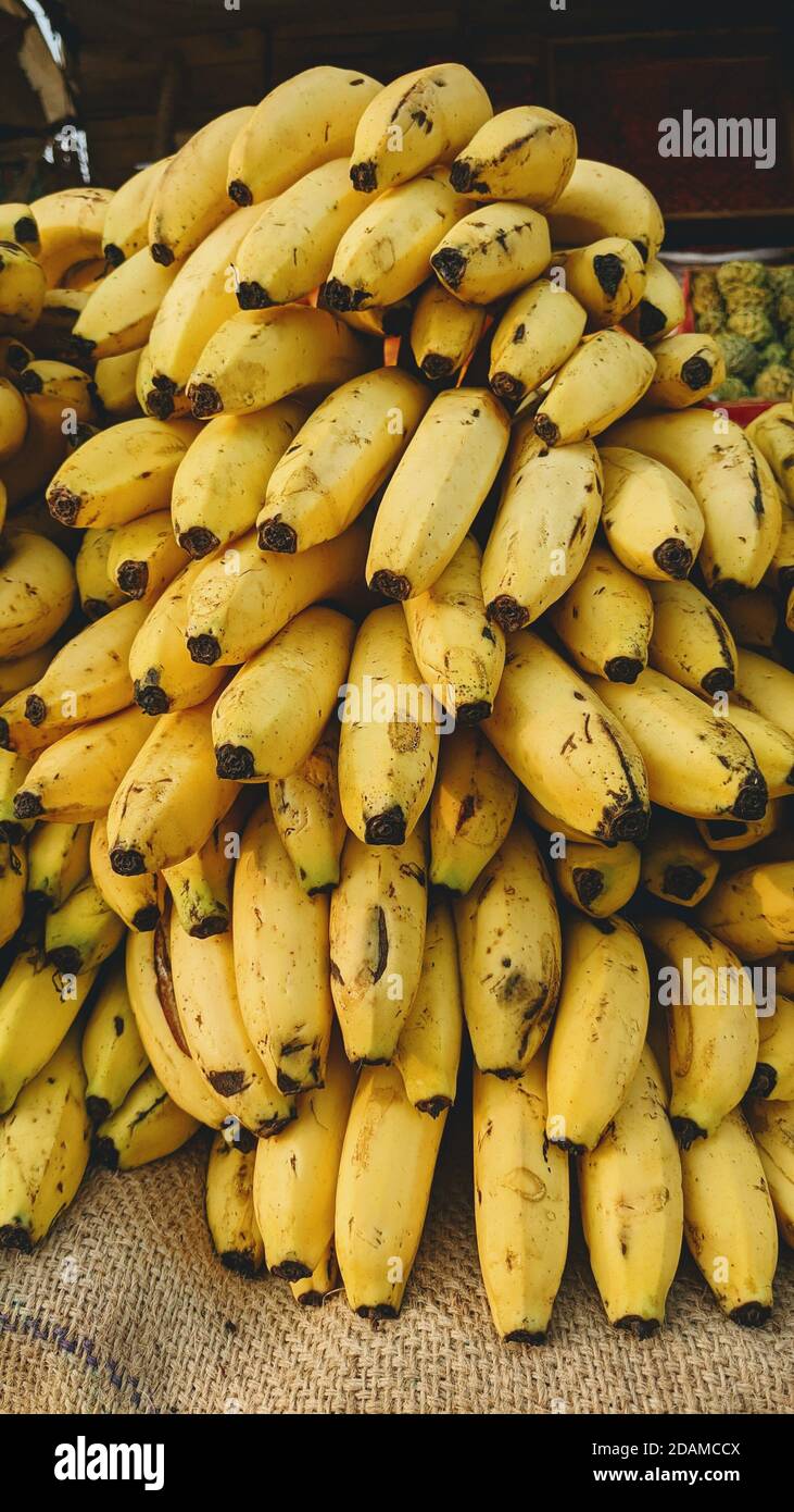 Vertical shot of ripe bananas on each other in an outdoor market at ...