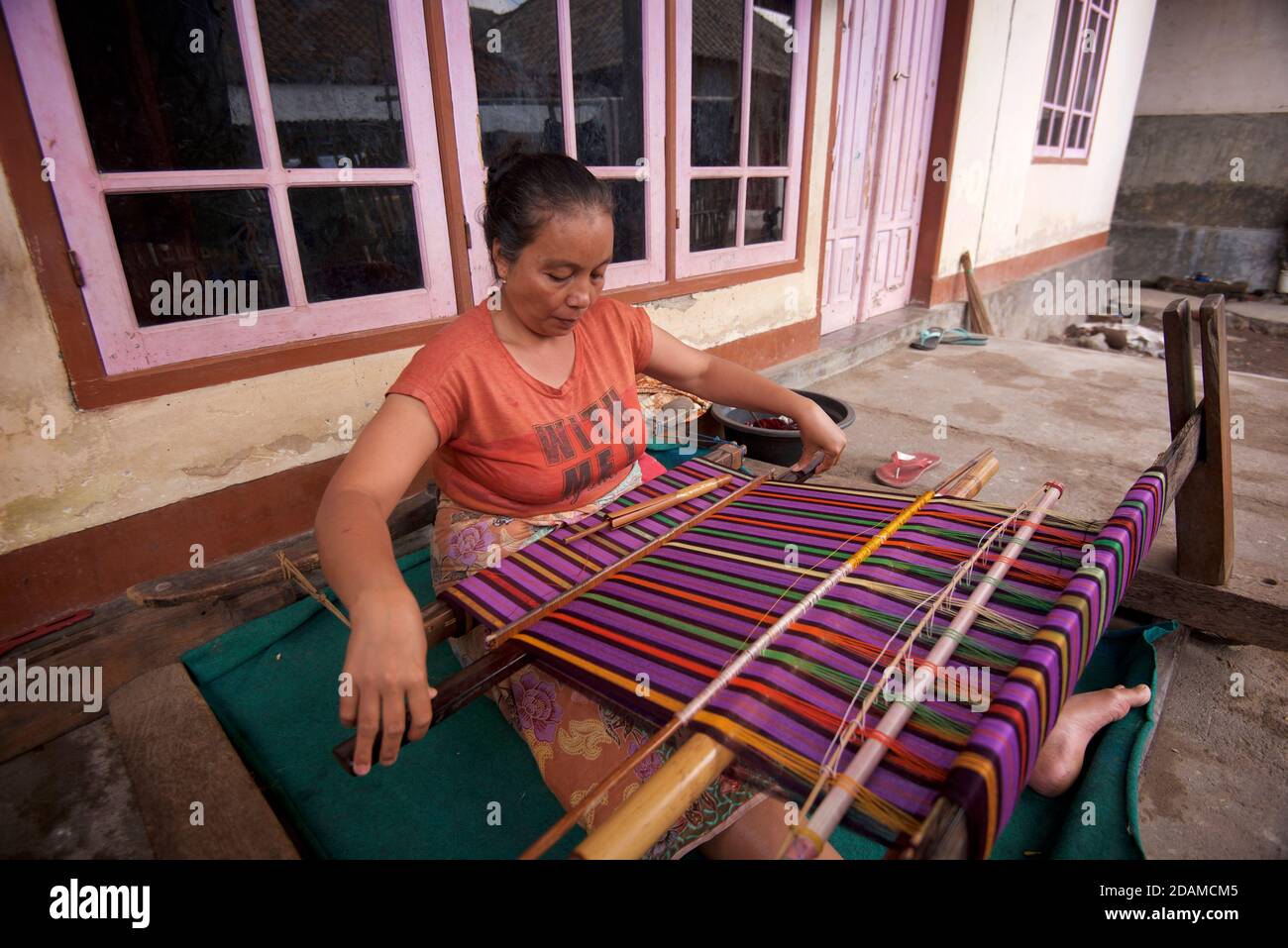 Local weaver. Woman weaving on a backstrap loom, Pringgasela, Lombok ...