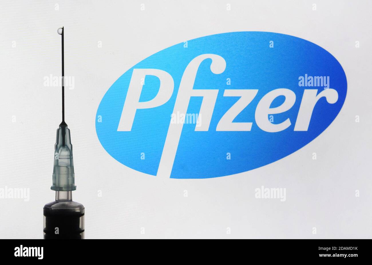 In this photo illustration a syringe seen in front of American ...