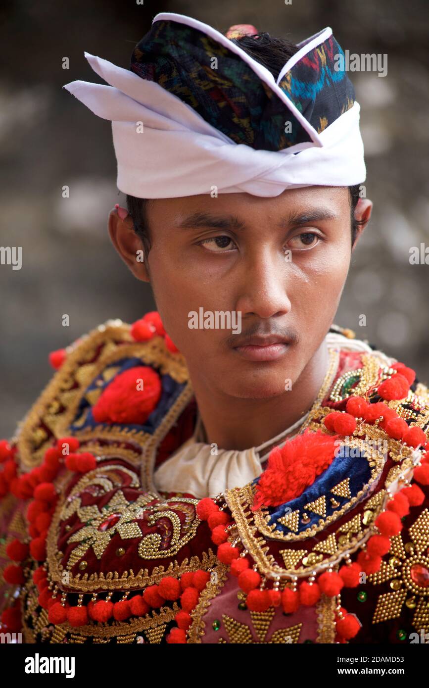 Young Balinese man in festive dance wear for temple ceremonial dance ...
