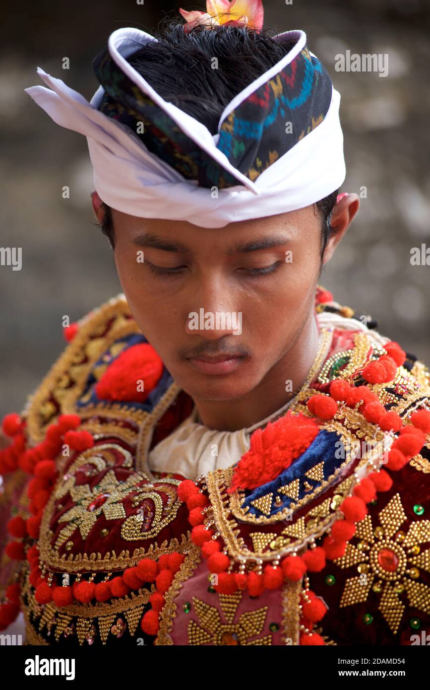 Young Balinese man in festive dance wear for temple ceremonial dance ...