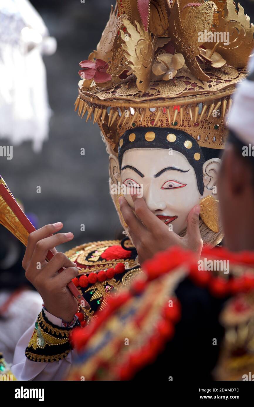Young Balinese woman in festive dance wear for temple ceremonial dance ...