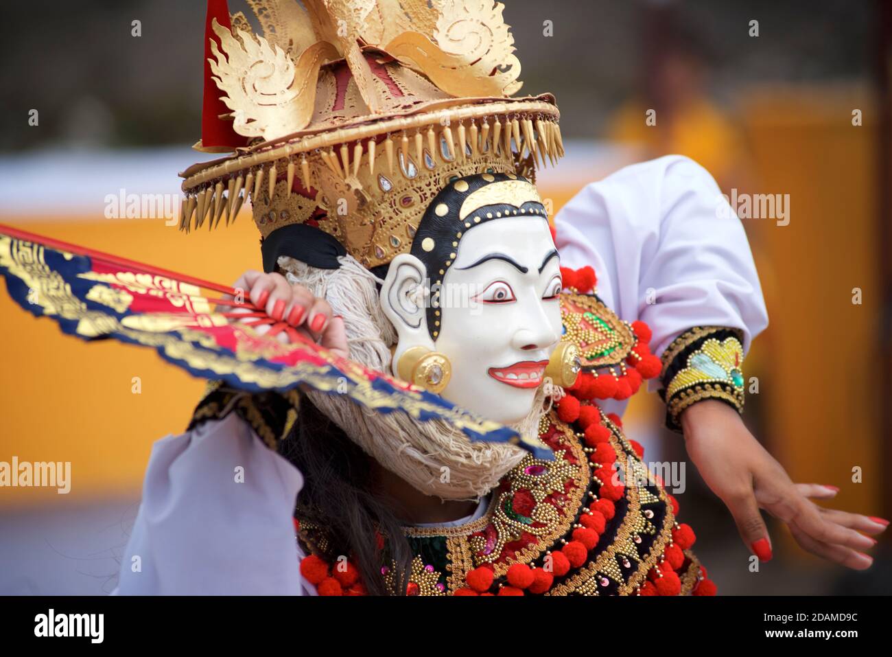Young Balinese woman in festive dance wear for temple ceremonial dance ...