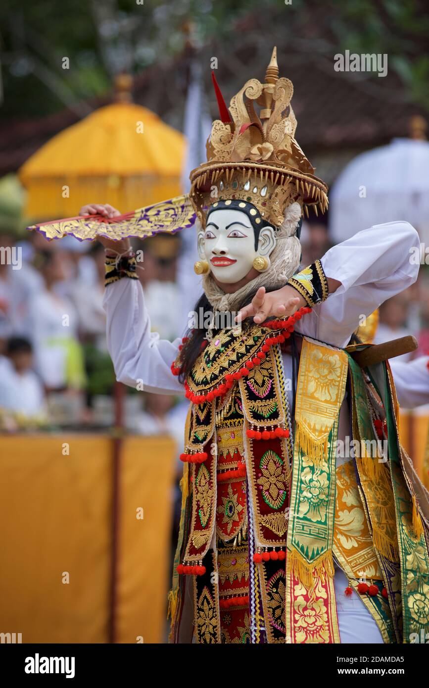 Young Balinese woman in festive dance wear for temple ceremonial dance ...