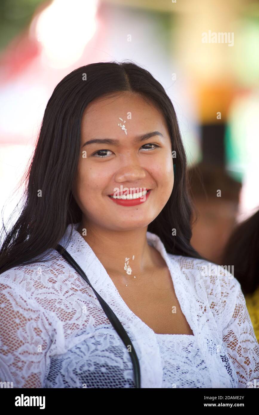 Portrait of a smiling Balinese woman attending a Hindu ceremony at ...