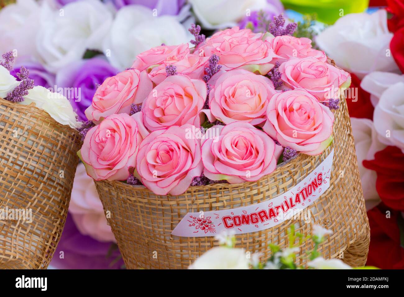 closeup bouquet of red artificial flower with word CONGRATULATIONS ...
