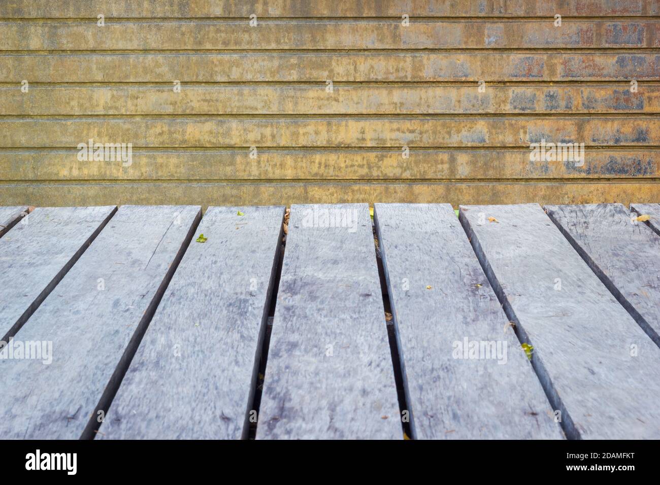 closeup perspective wooden deck with the background of horizontal rusty ...