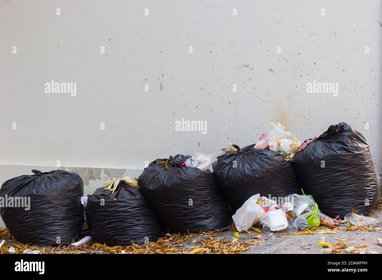 black bags of garbage and waiste on blank dirty wall Stock Photo - Alamy