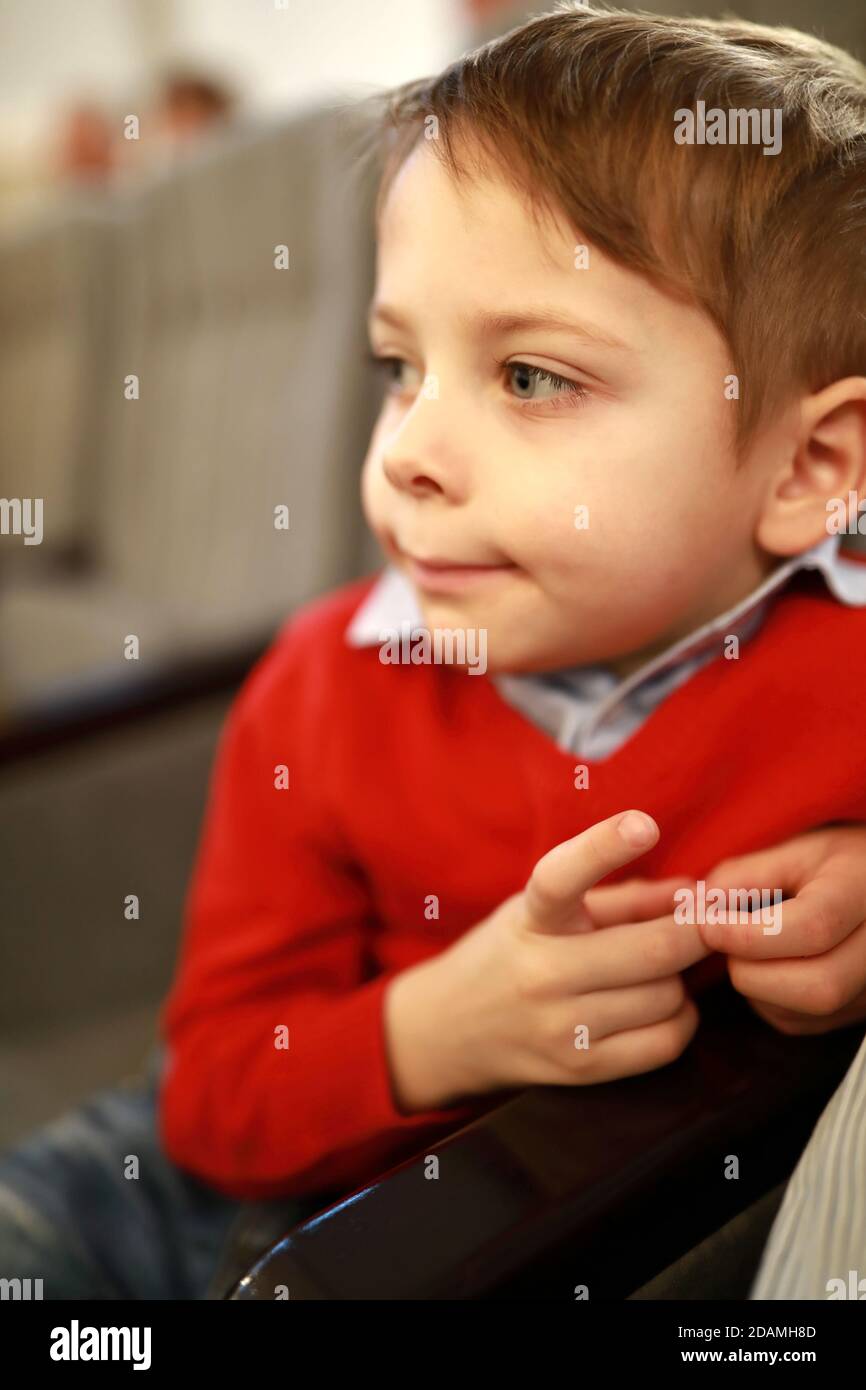 Pensive child watching a performance in a theater Stock Photo - Alamy