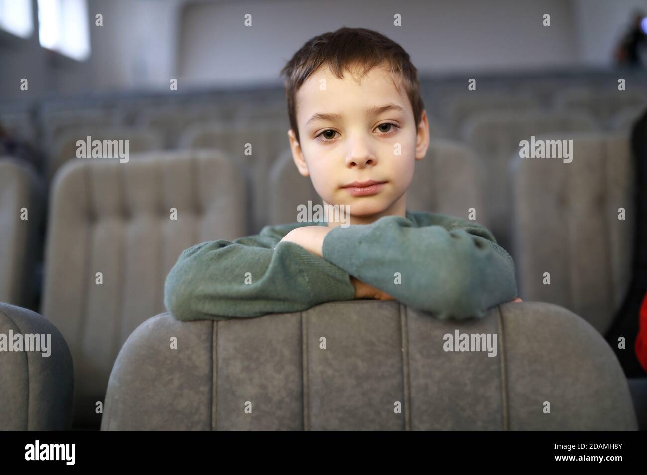 Boy watching a performance in a theater Stock Photo - Alamy