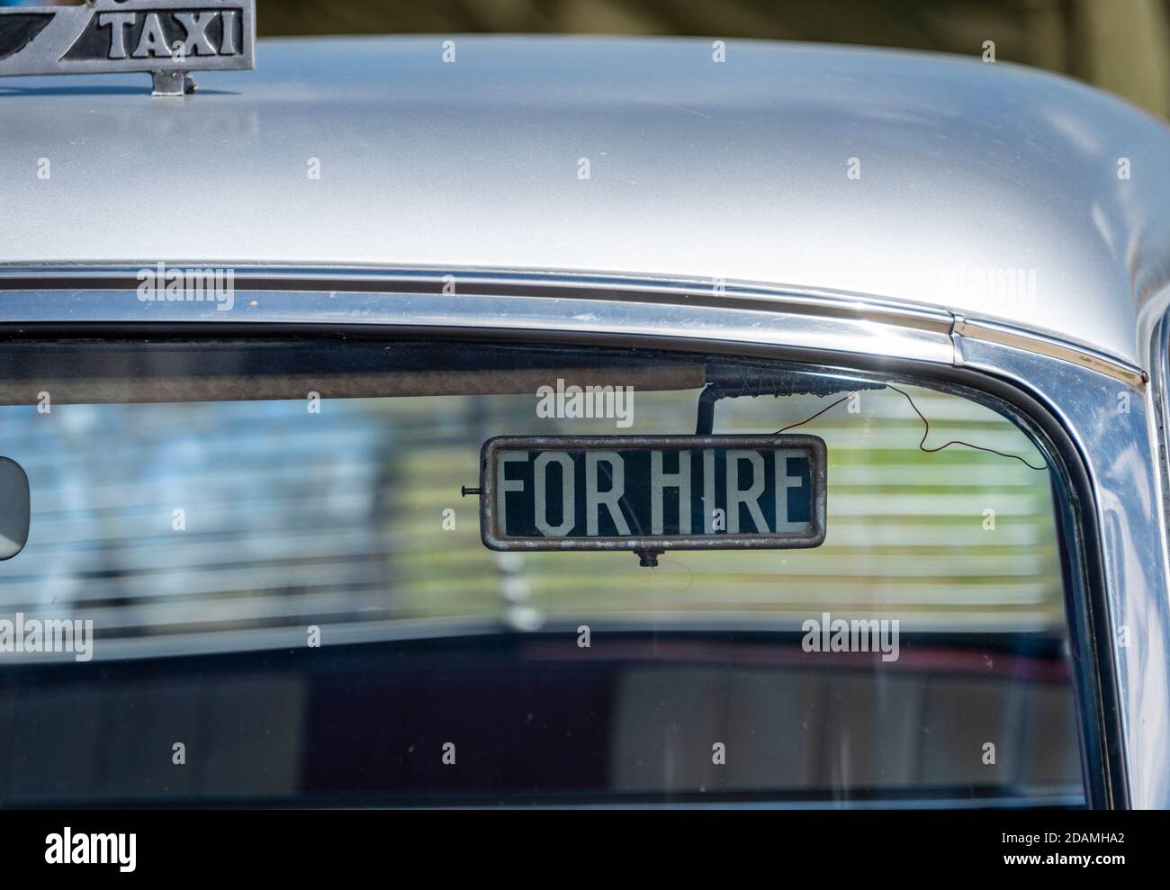 A For Hire sign in the windscreen of an old sliver cab Stock Photo - Alamy