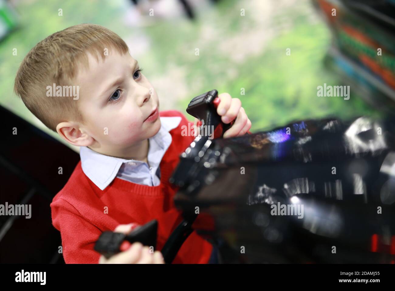 Boy playing toy machine gun in amusement park Stock Photo - Alamy