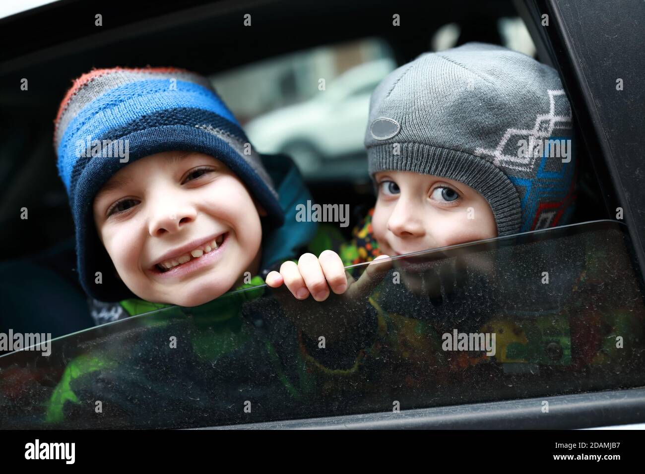 Two children in car window hi-res stock photography and images - Alamy