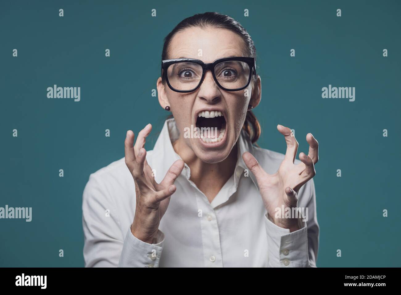 Aggressive angry woman shouting at camera, she is feeling furious and ...