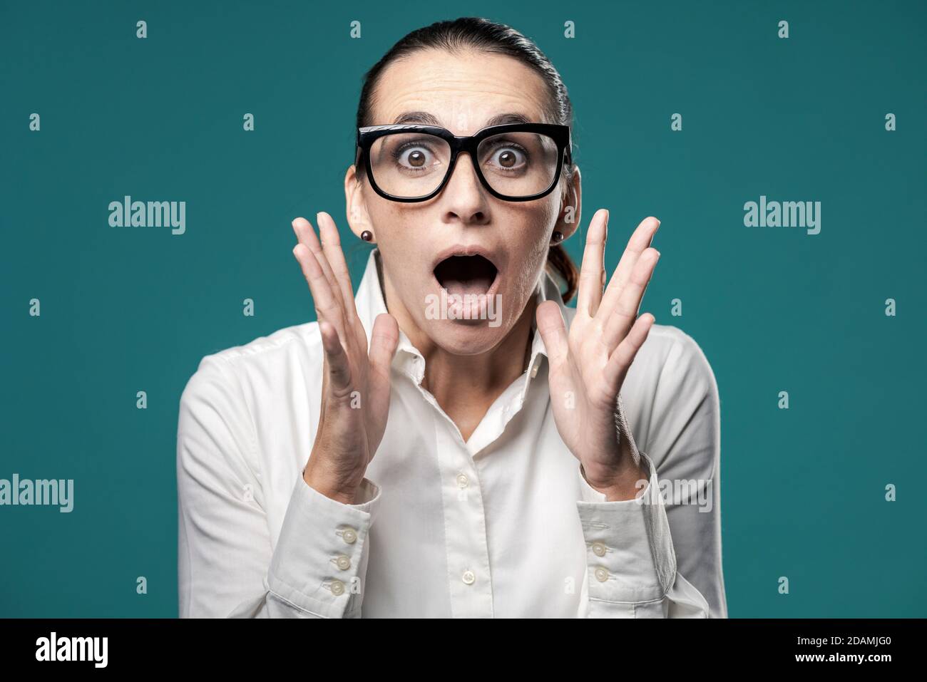 Shocked scared woman screaming and looking at camera, she has made a ...