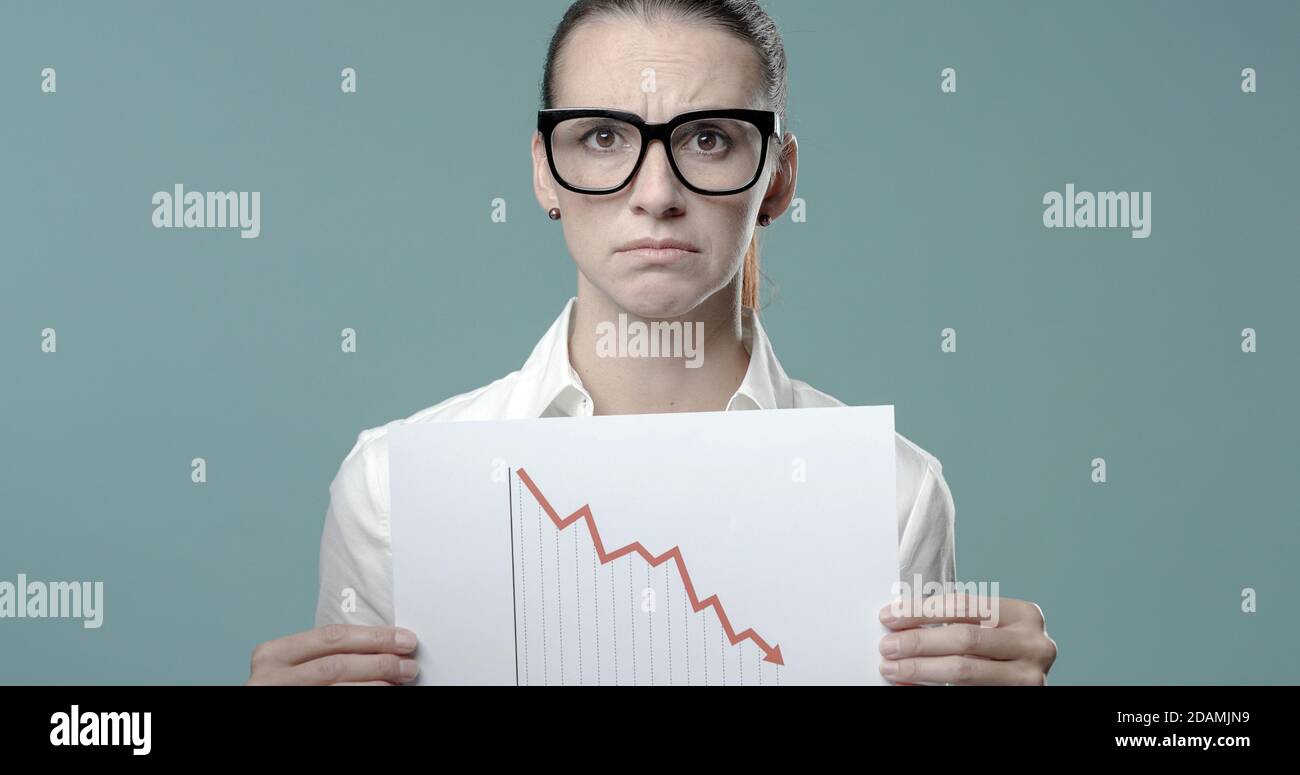 Businesswoman holding a negative financial chart, financial crisis and ...