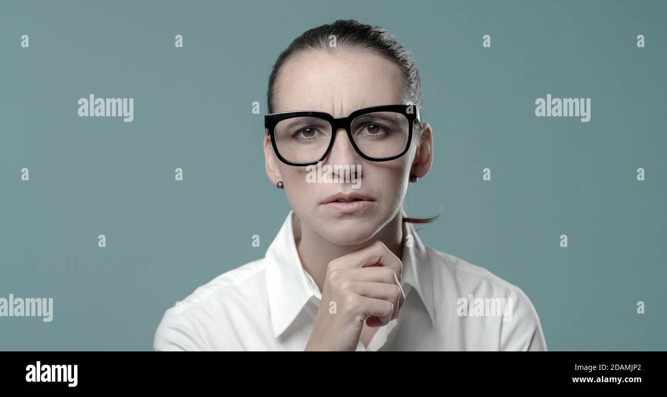 Worried pensive woman thinking with hand on chin, she is making a ...