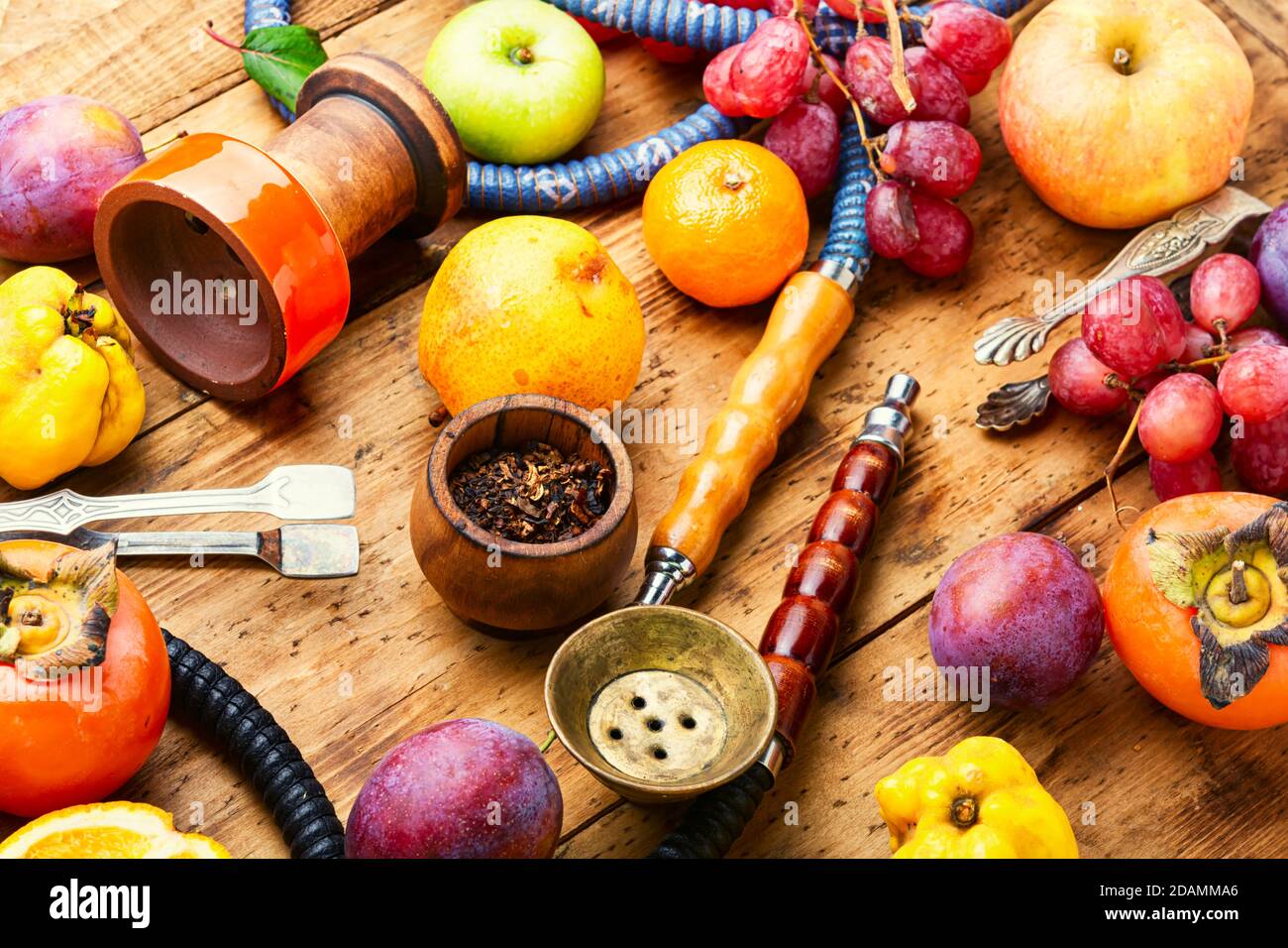 Smoking hookah with fresh fruit aroma.Tobacco fruit shisha.Making ...