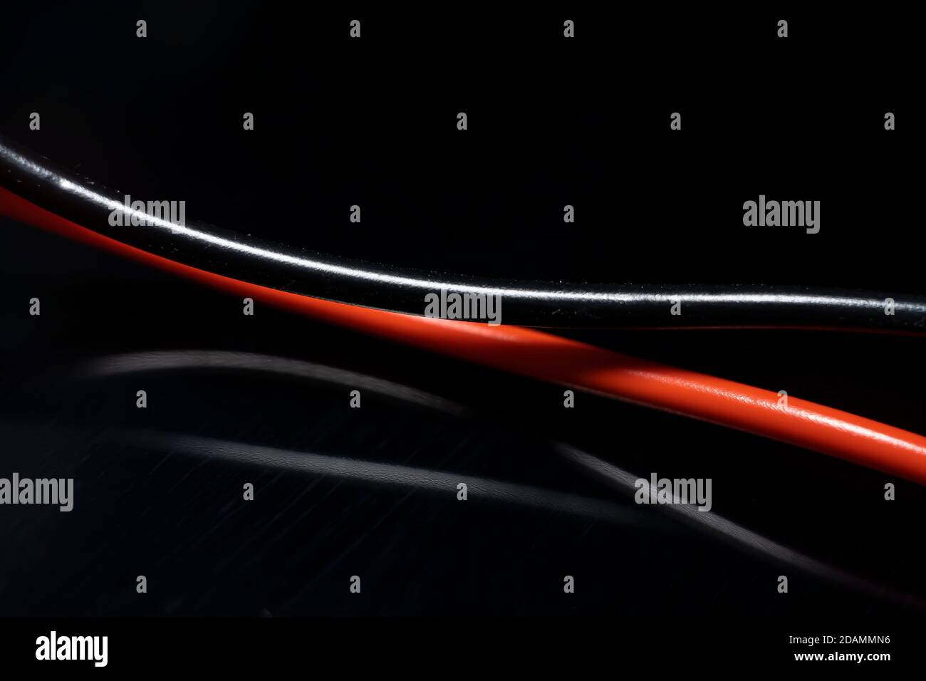red and black wire on a black background Stock Photo - Alamy