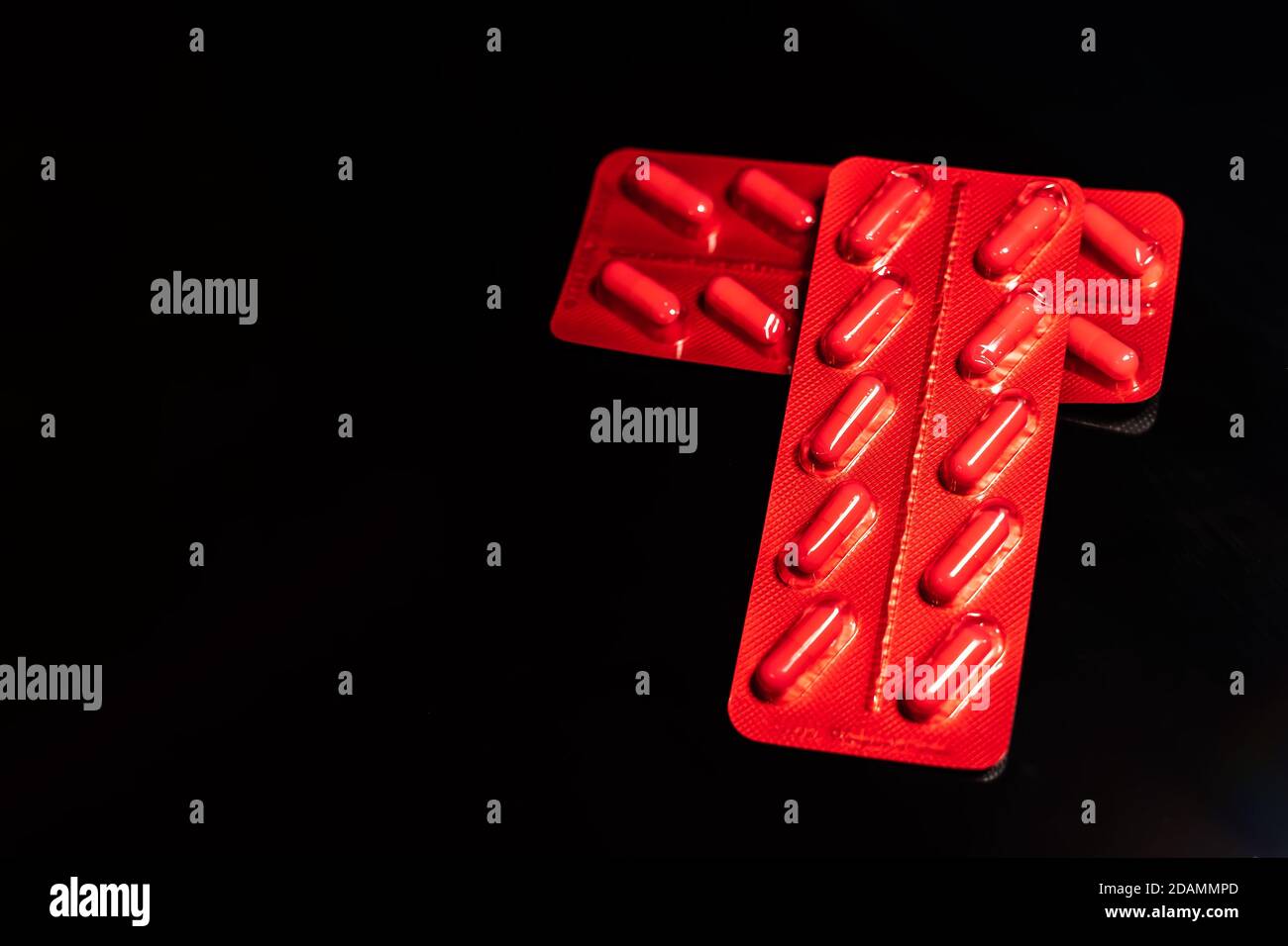 packages of tablets in a red wrapper on a black background Stock Photo ...