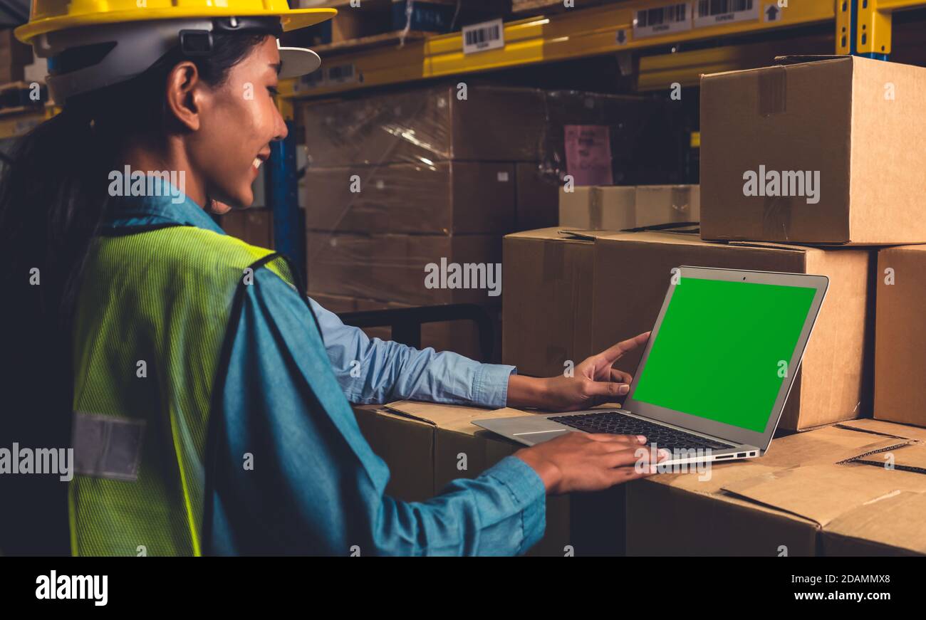 Computer with green screen display in warehouse storage room . Delivery ...