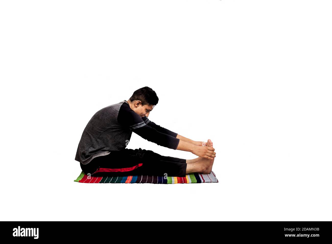 Shot of a young teenager doing Full forward bend or caterpillar or ...