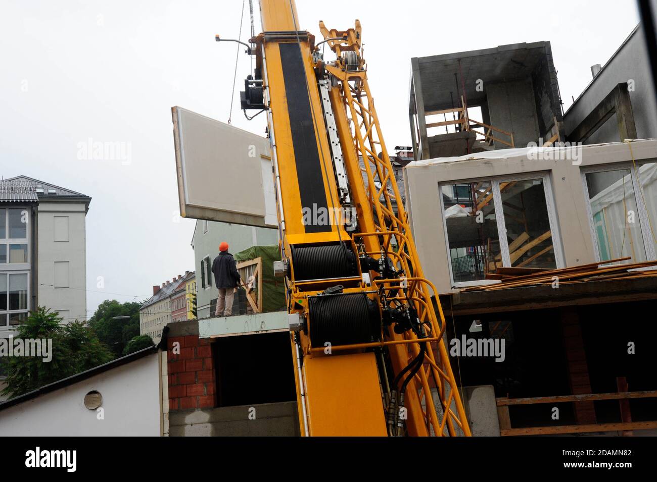 worker next to heavy machinery at the construction of a prefabricated ...