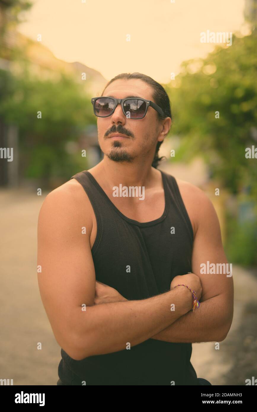 Handsome man with curly hair and mustache in the streets outdoors Stock ...