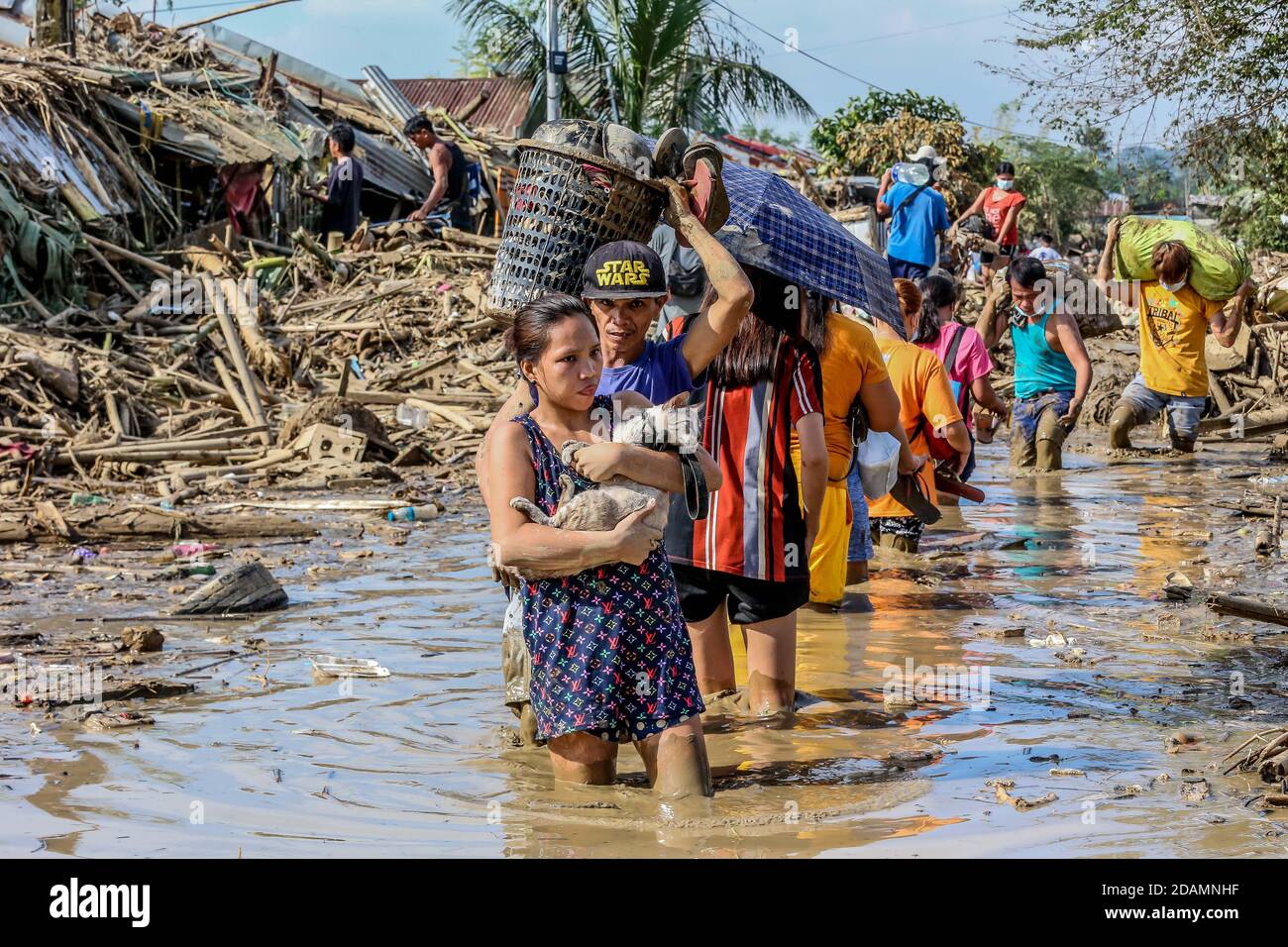 Rizal Province, Philippines. 14th Nov, 2020. Residents walk in knee ...