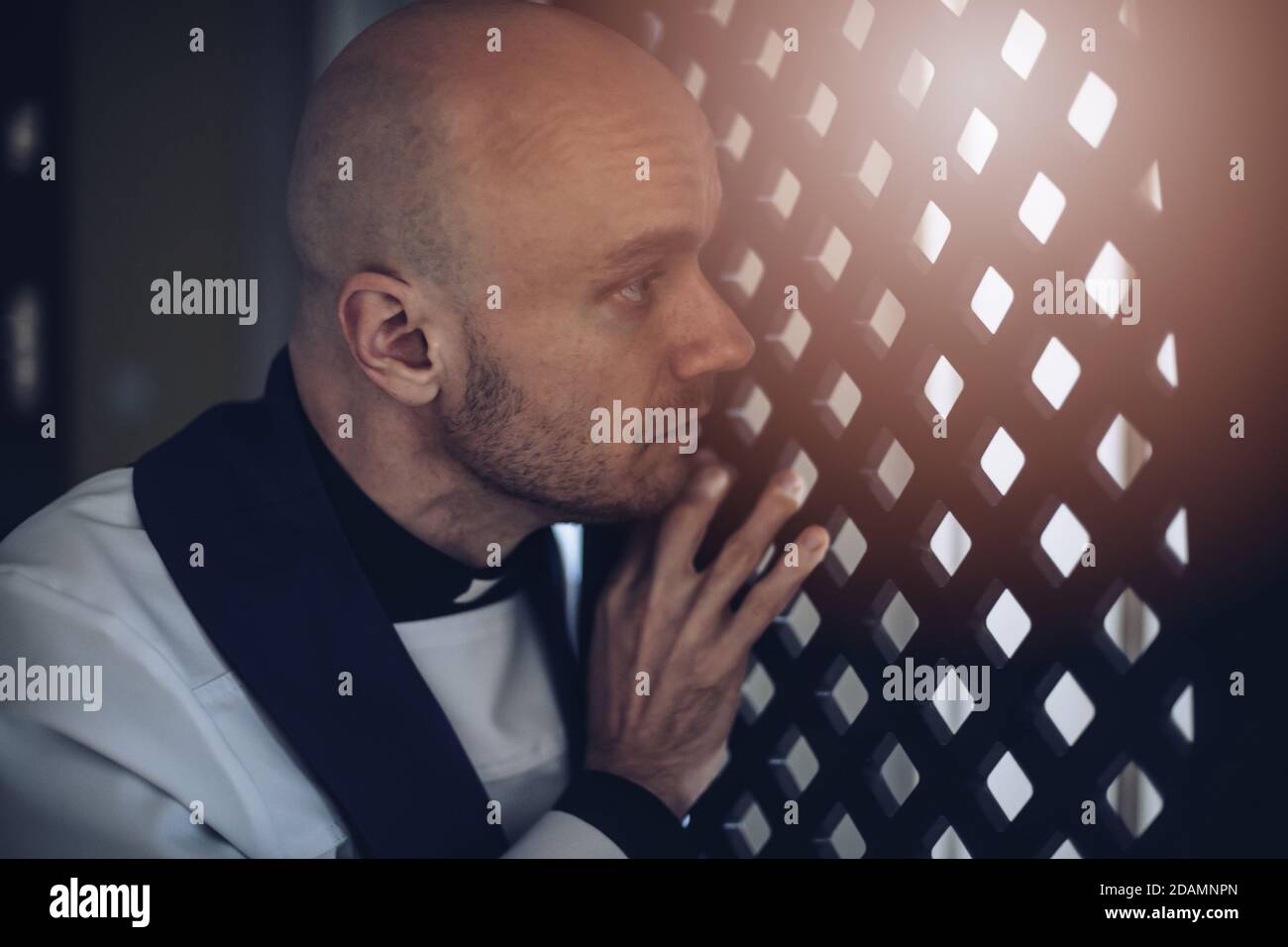 A Catholic priest confesses in the confessional Stock Photo - Alamy