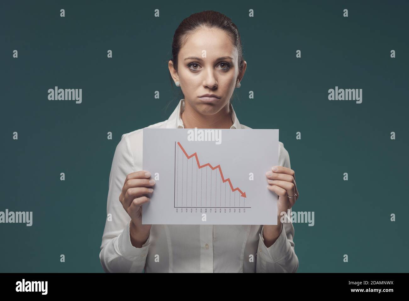 Disappointed businesswoman holding a negative financial chart, financial crisis and business ...